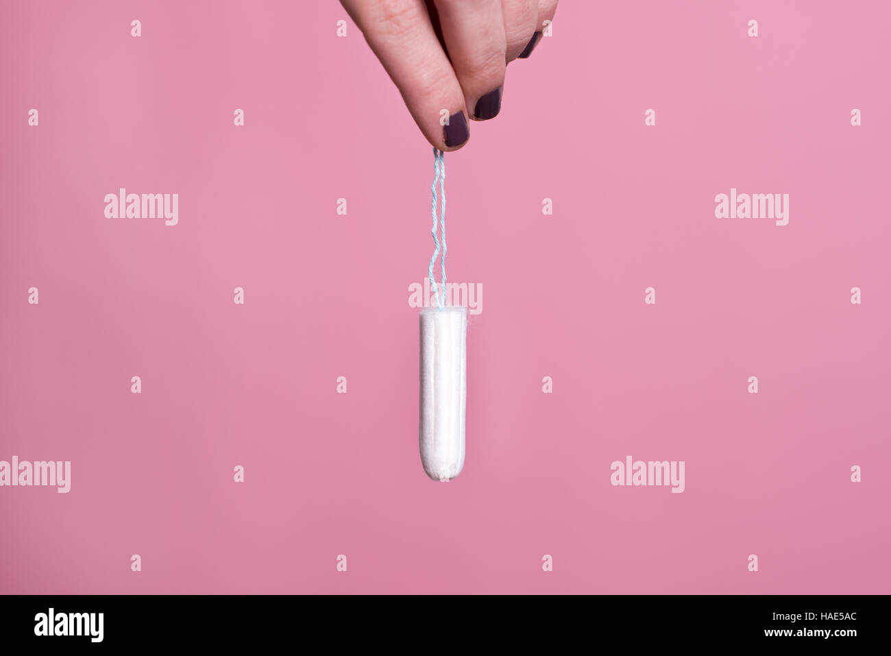 Woman's hand holding a clean cotton tampon Stock Photo - Alamy