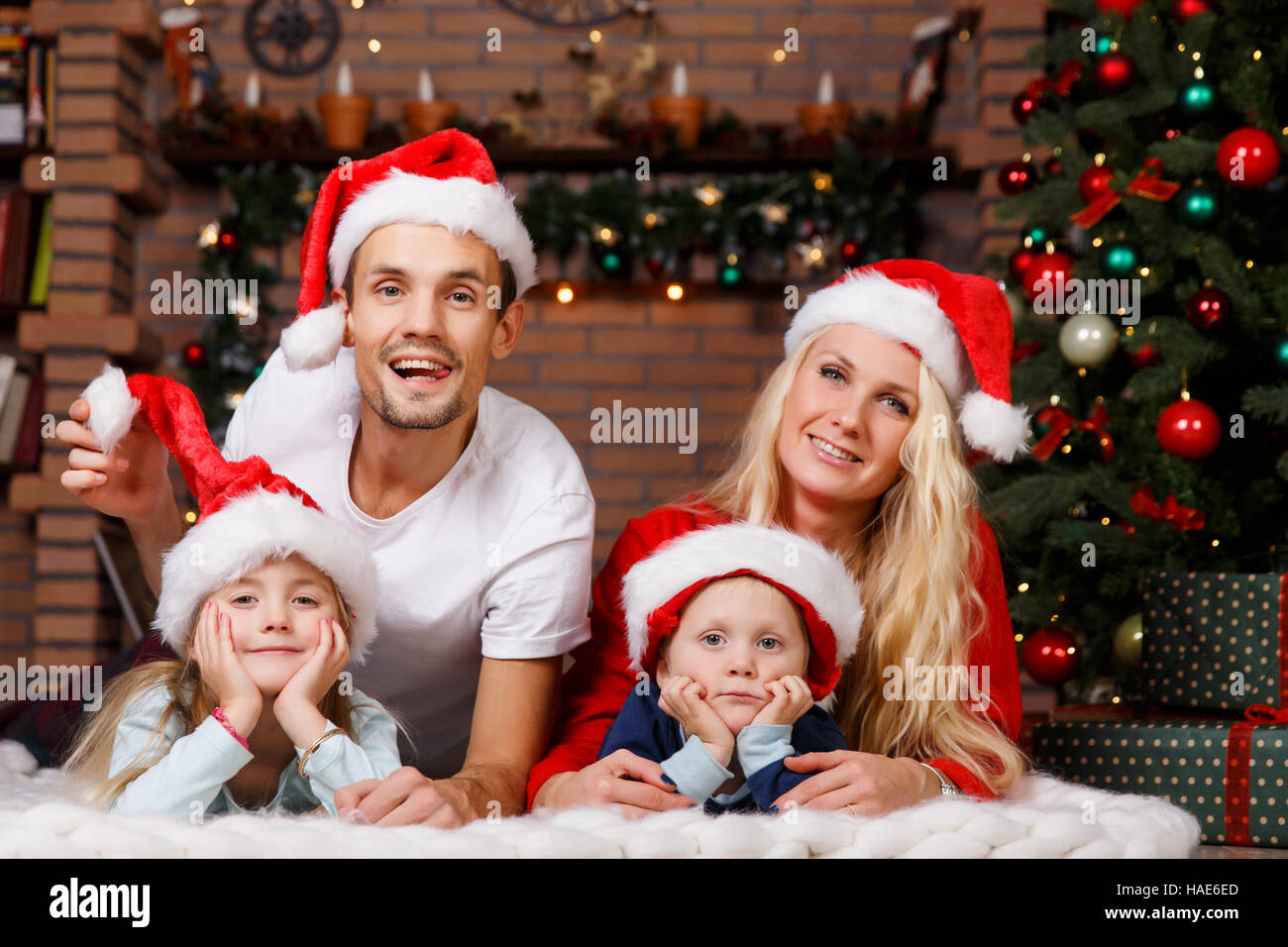 Beautiful family lying on rug Stock Photo - Alamy