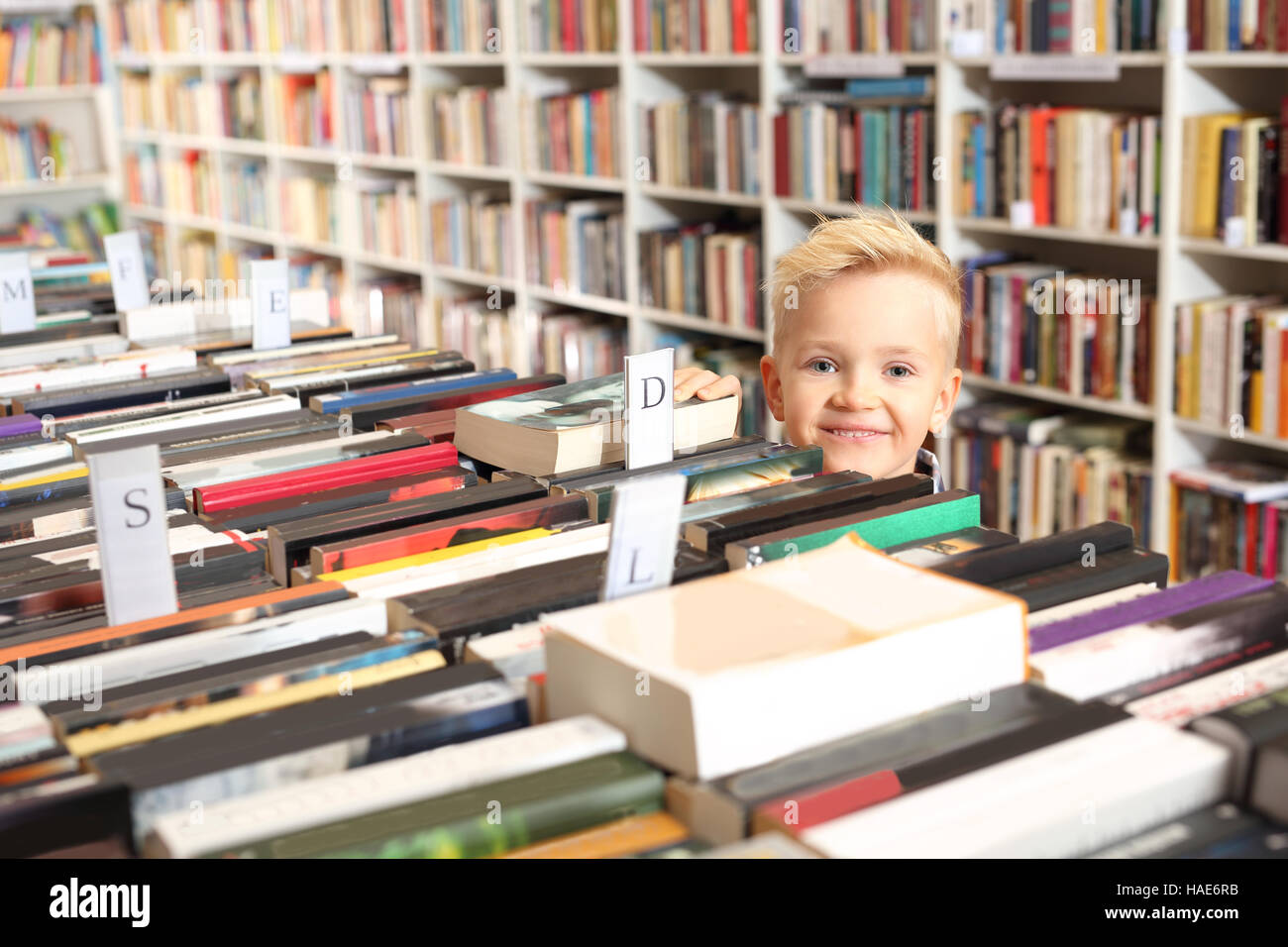 Small student in the library. The boy in the school library Stock Photo ...