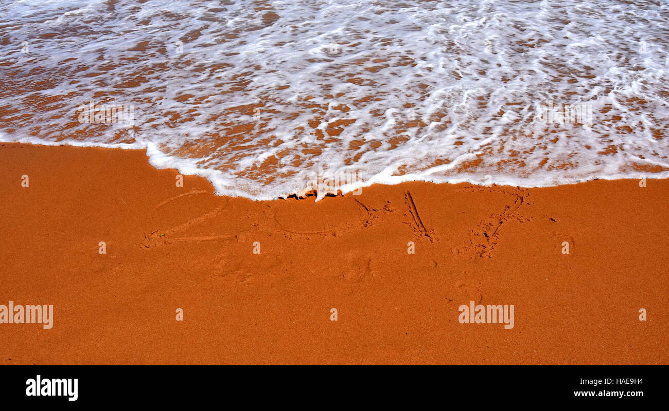 2017 written on sand at sunset. 2017 lettering on the beach. "2017 ...