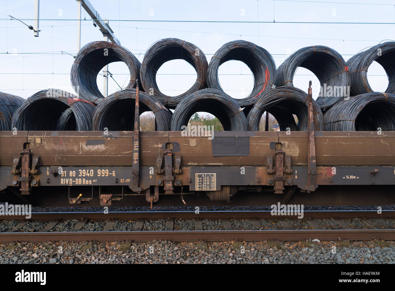 row of train cargo wagons with rolls of steel wire Stock Photo - Alamy