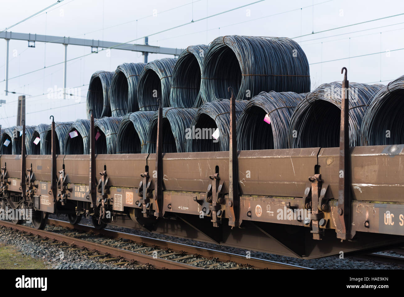 row of train cargo wagons with rolls of steel wire Stock Photo - Alamy
