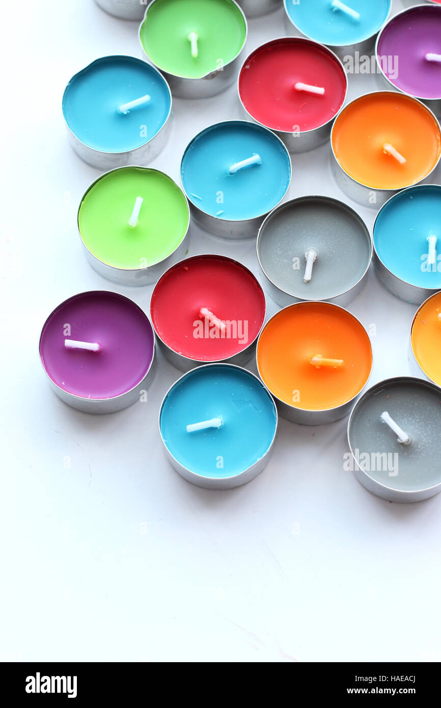 Colorful scented candles against white background Stock Photo - Alamy