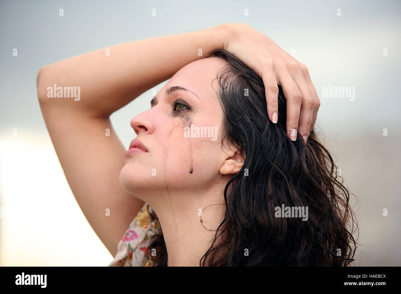 Portrait of a young crying brunette Stock Photo - Alamy