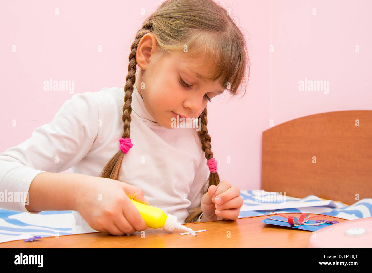Girl Apply glue to the crafts out of colored paper Stock Photo - Alamy