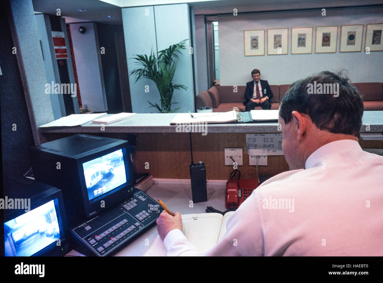 Security Guard in office reception Stock Photo - Alamy