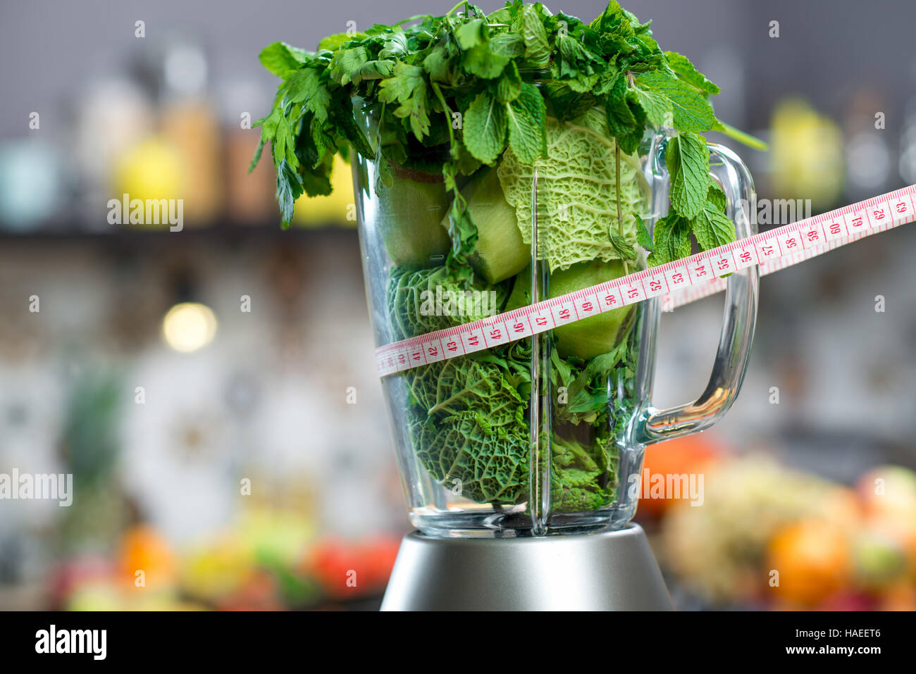 Blender with green ingredients Stock Photo - Alamy