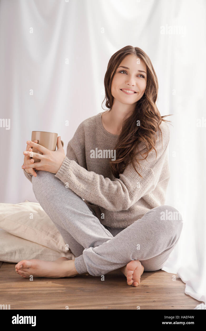 beautiful woman drinking coffee, sitting by window Stock Photo - Alamy