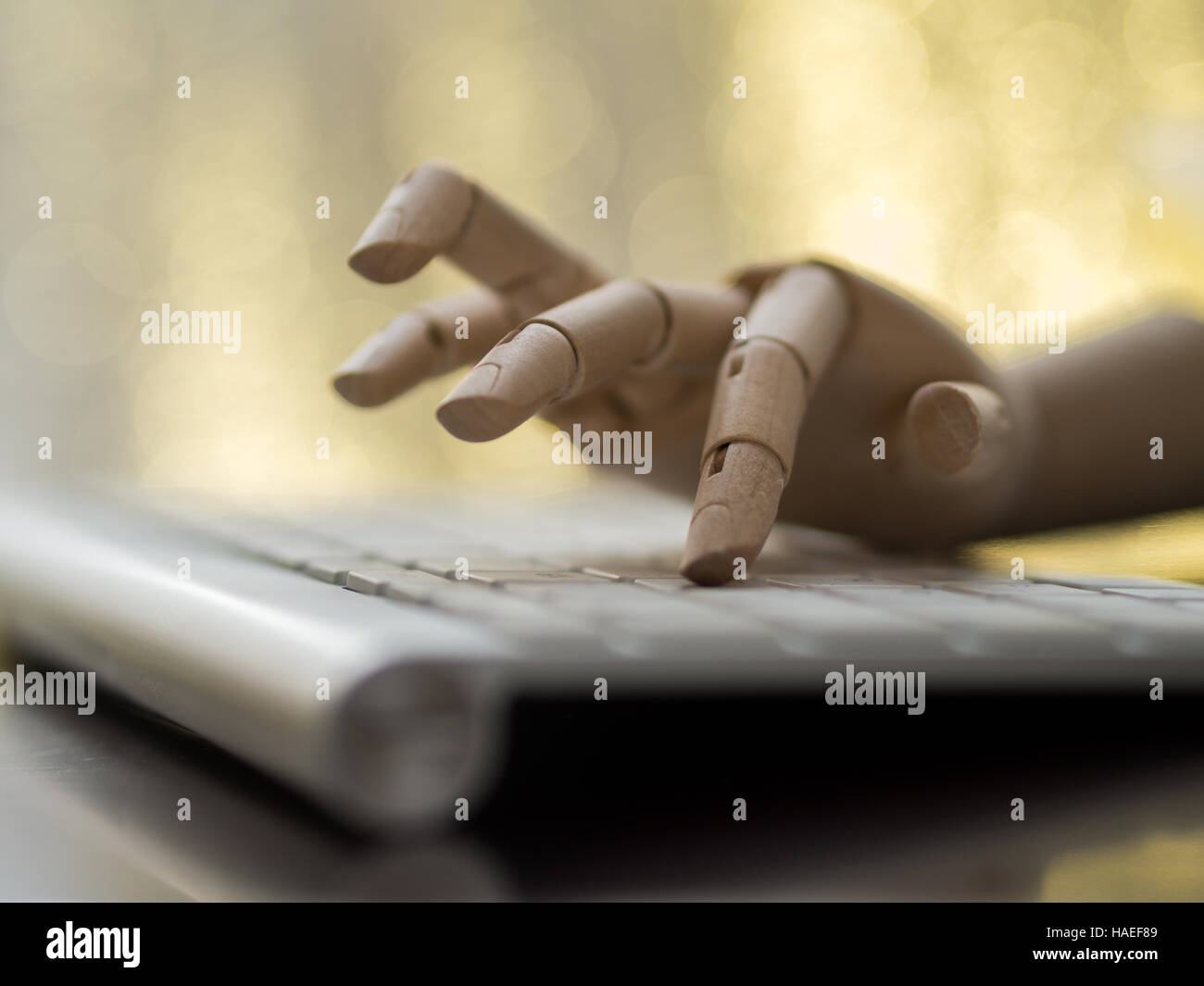 Wooden dummy hand on a computer keyboard Stock Photo - Alamy