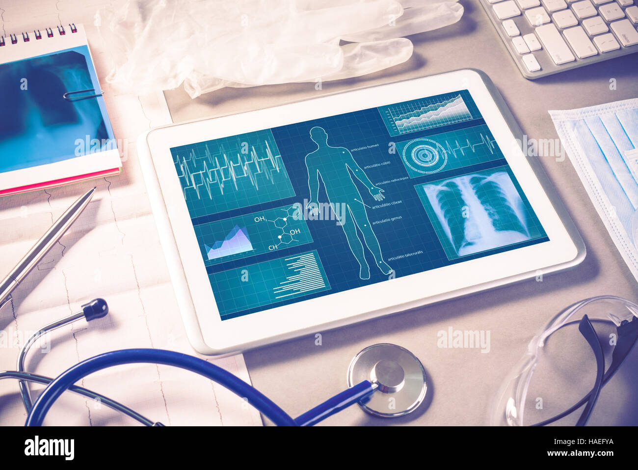 White tablet pc and doctor tools on gray surface Stock Photo - Alamy