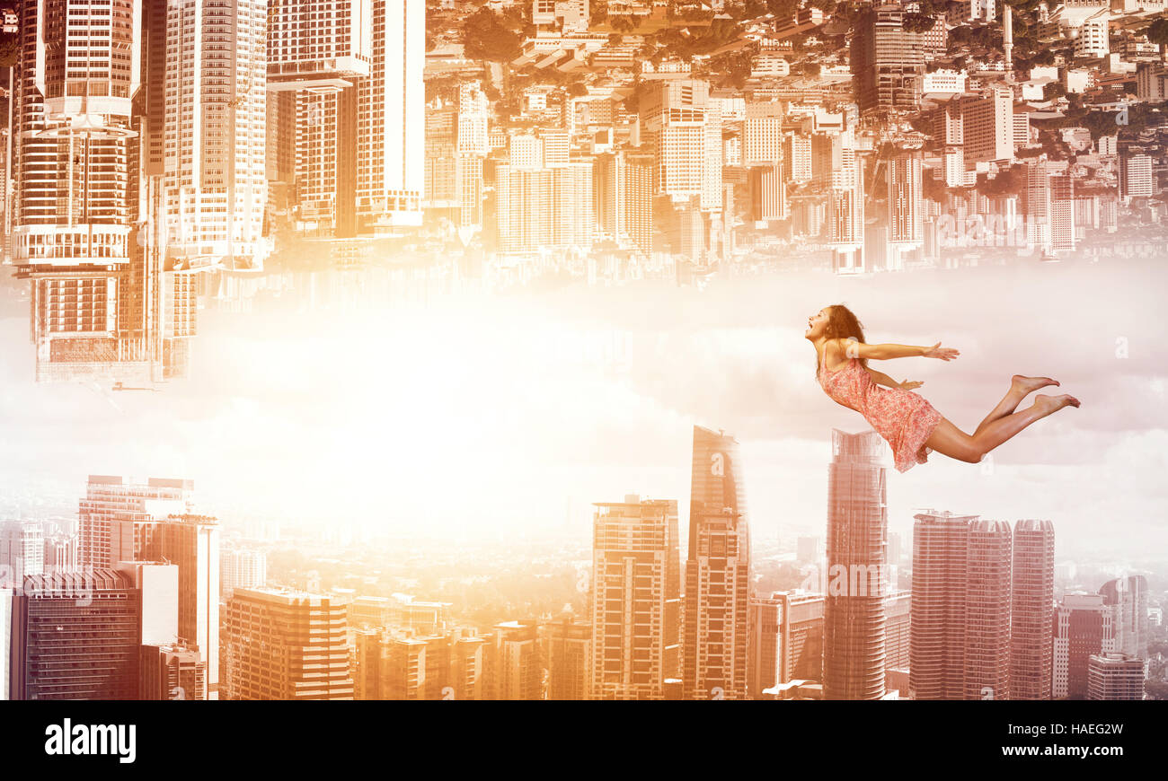 Young woman flying between two reality worlds Stock Photo - Alamy