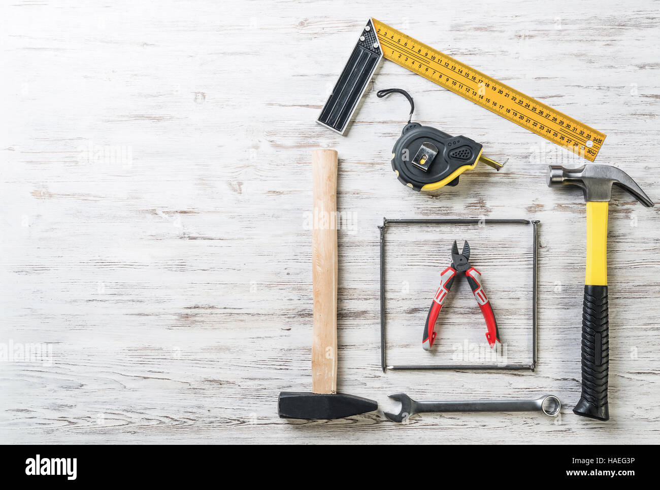 Variety of repair tools on wooden surface Stock Photo - Alamy