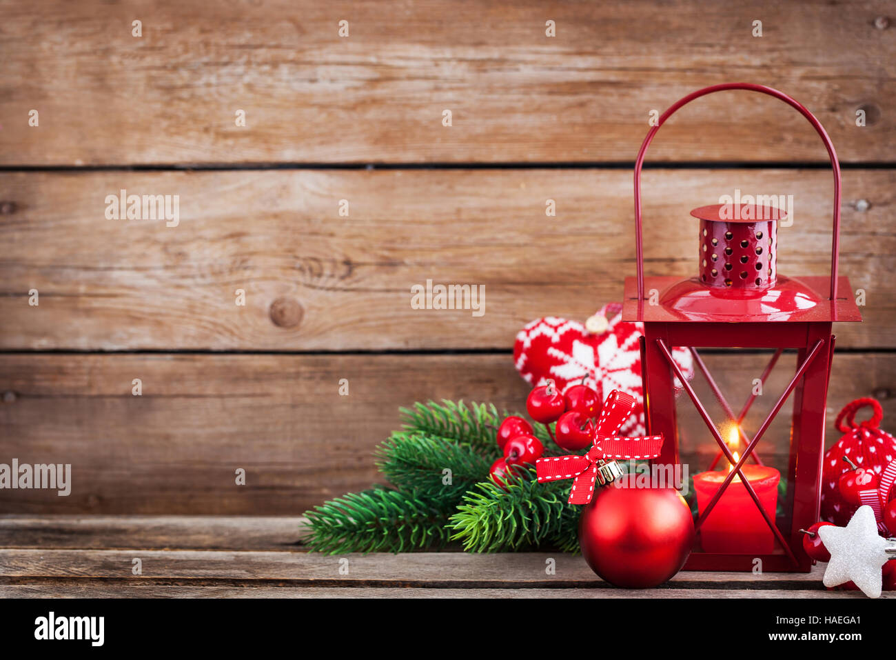 Christmas time red latern with candle light and holiday decorations ...