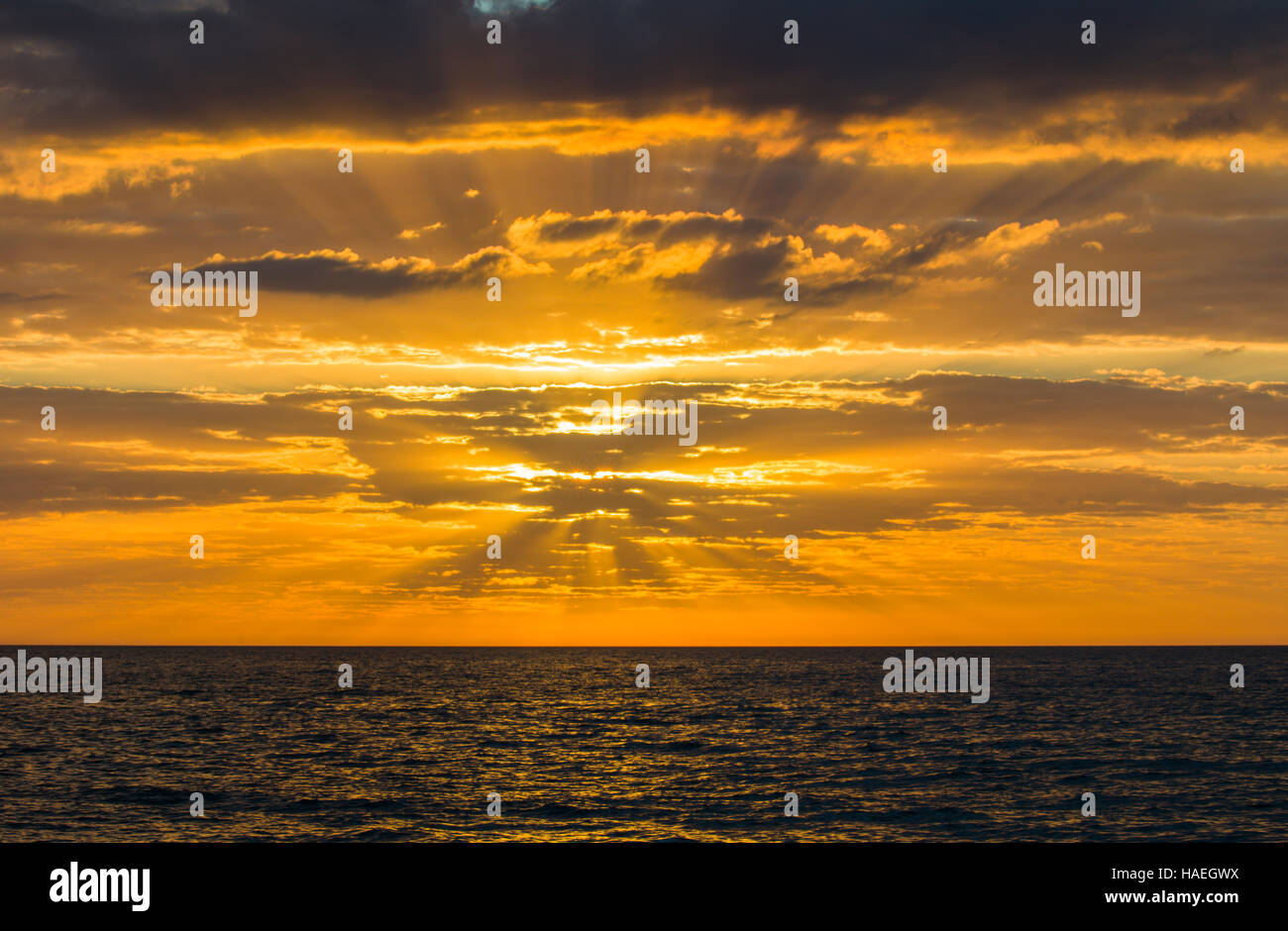 Orange colorful sunset with God Rays over the Gulf of Mexico from ...
