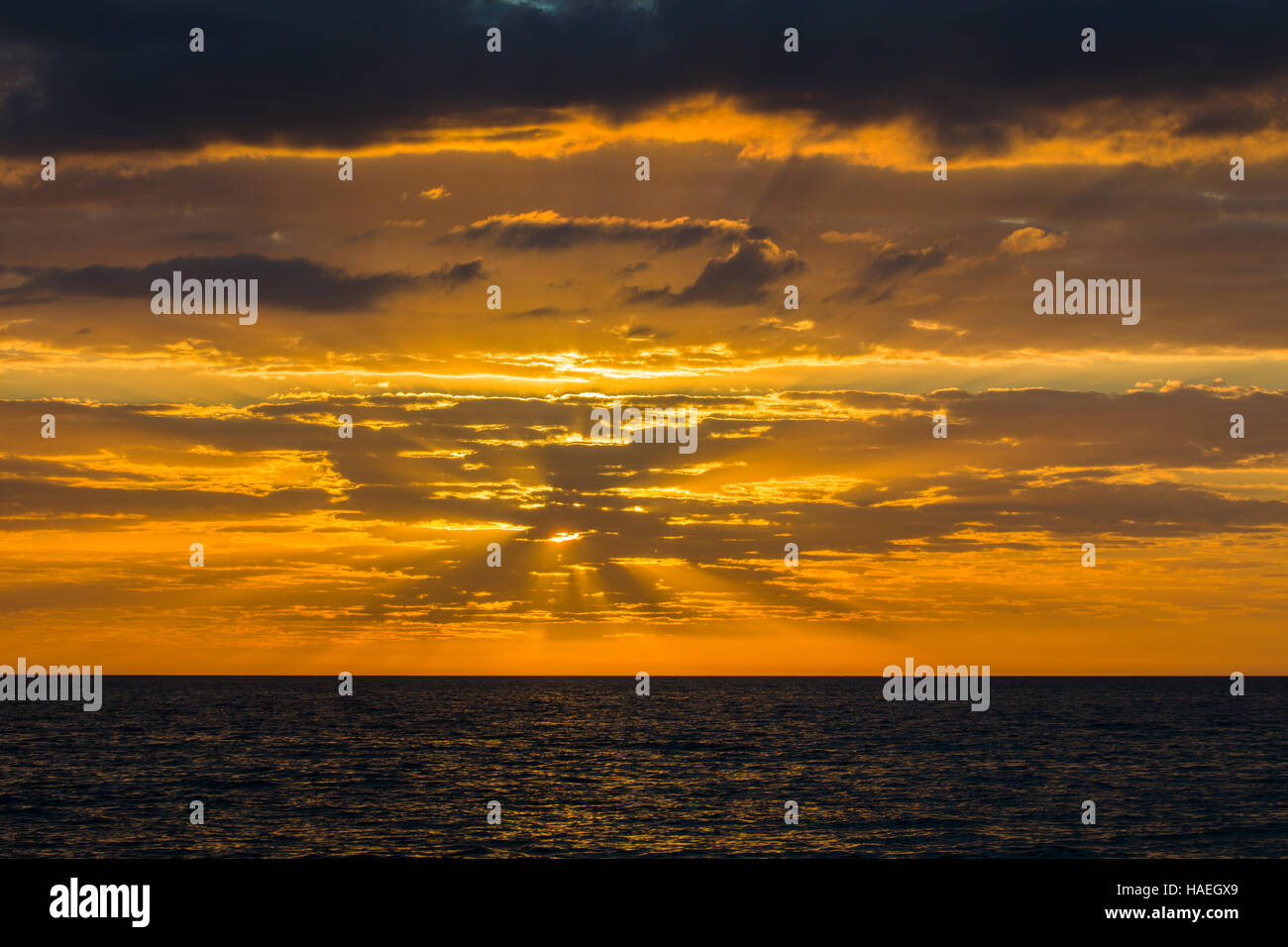 Orange colorful sunset with God Rays over the Gulf of Mexico from ...