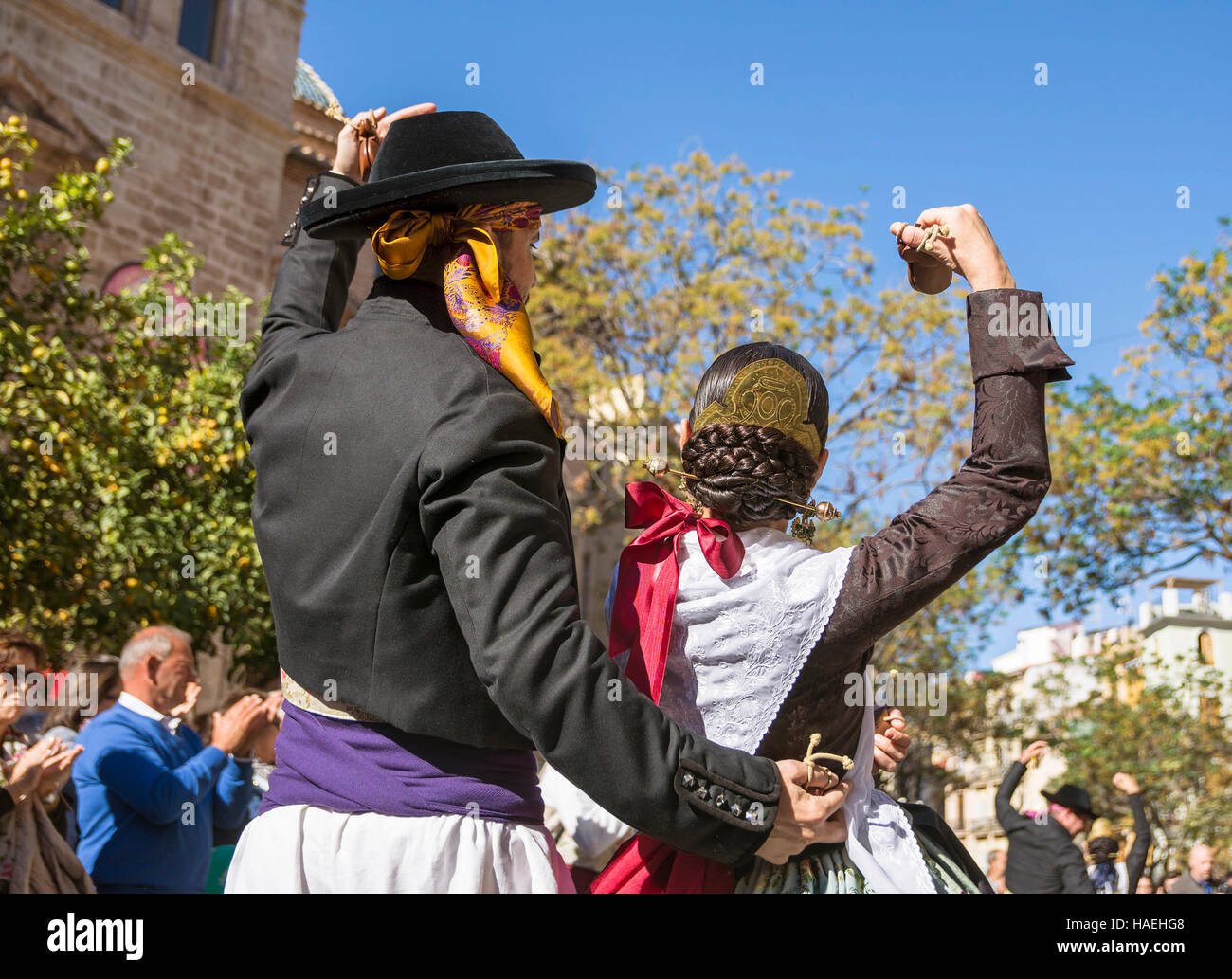 Man and women in local costumes,perform a traditional dance on Plaza ...
