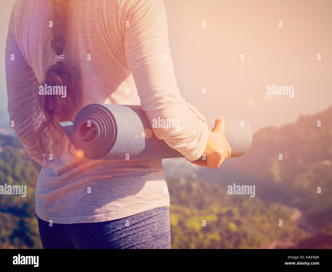 Woman standing with yoga Stock Photo - Alamy