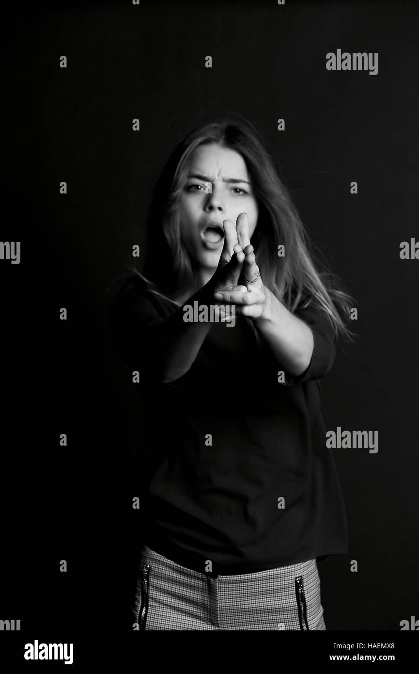 Beautiful girl. The gesture of fingers the gun Stock Photo - Alamy