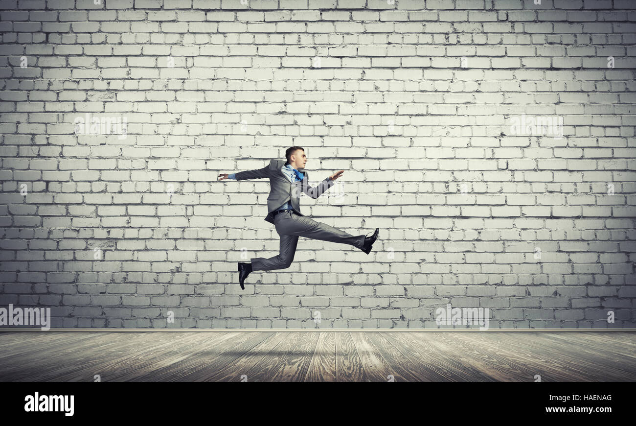 Businessman jumping high Stock Photo - Alamy