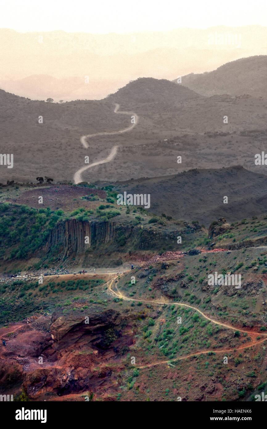 African rural countryside hills and road on a hazy day against yellow ...