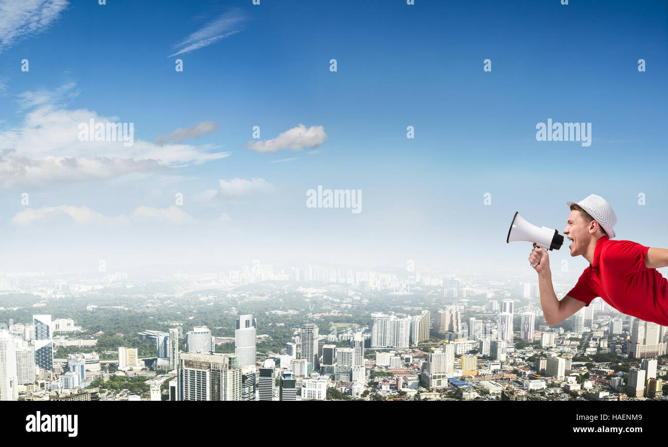 Guy screaming in loudspeaker Stock Photo - Alamy