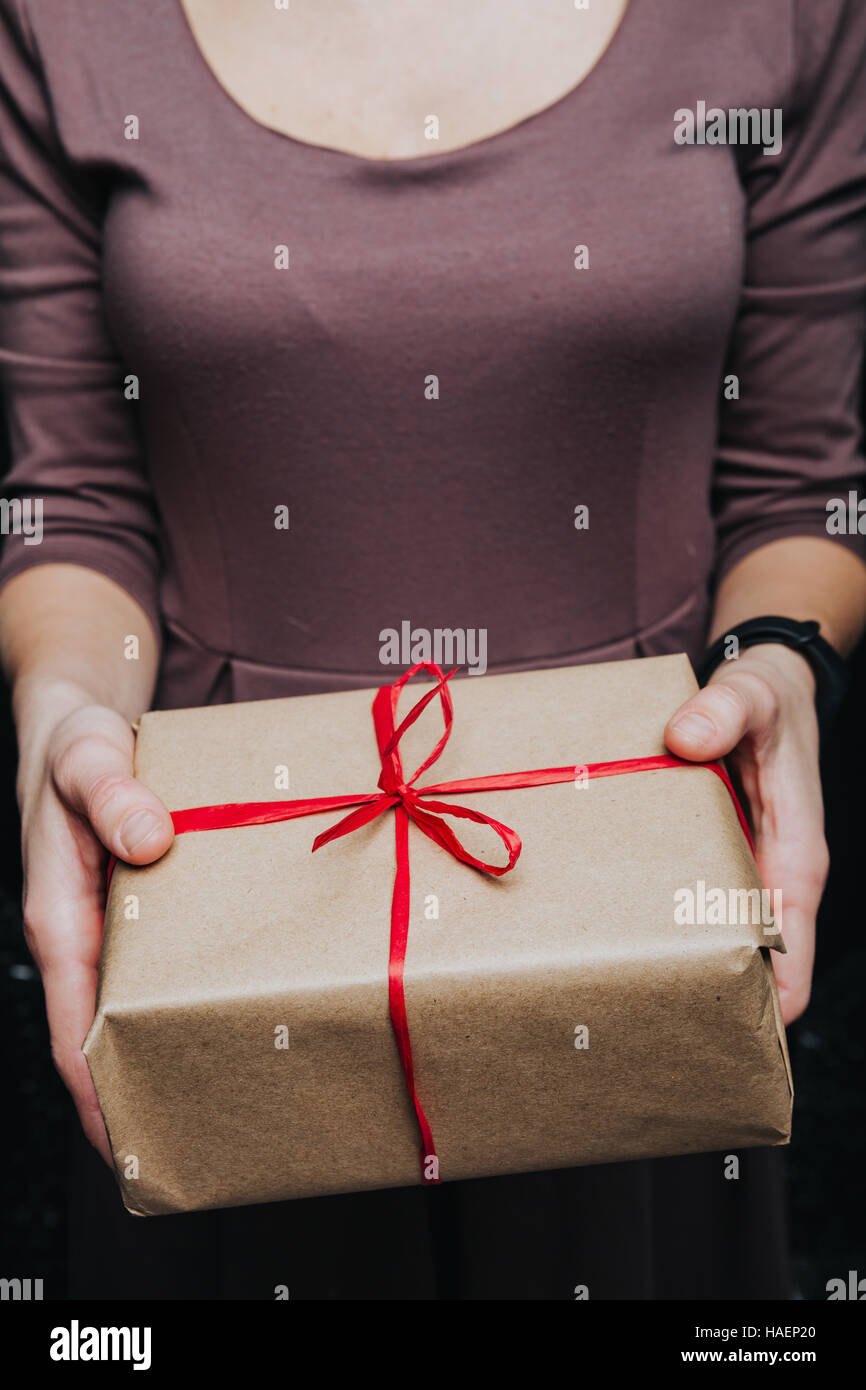 Crop hands holding wrapped present Stock Photo - Alamy
