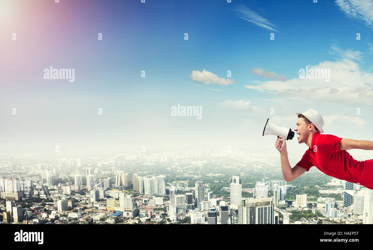 Guy screaming in loudspeaker Stock Photo - Alamy