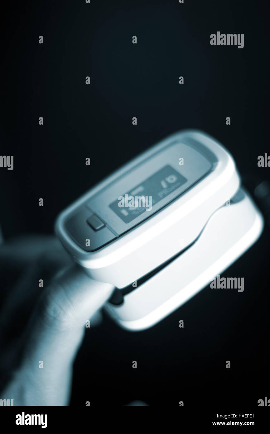 Portable hand held domestic cardiac finger pulse rate meter to show ...