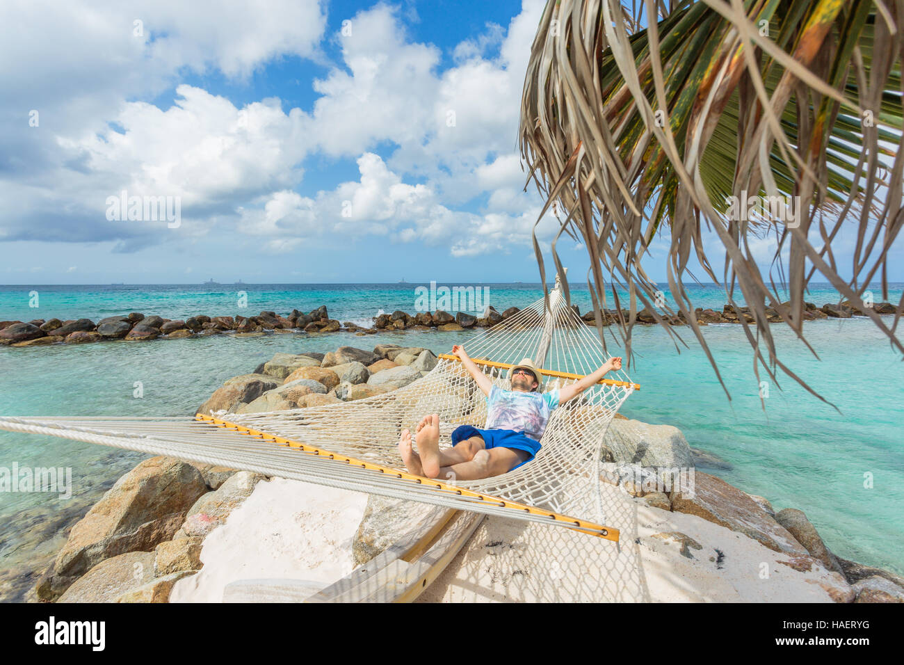 Man relaxing in a hammock Stock Photo - Alamy