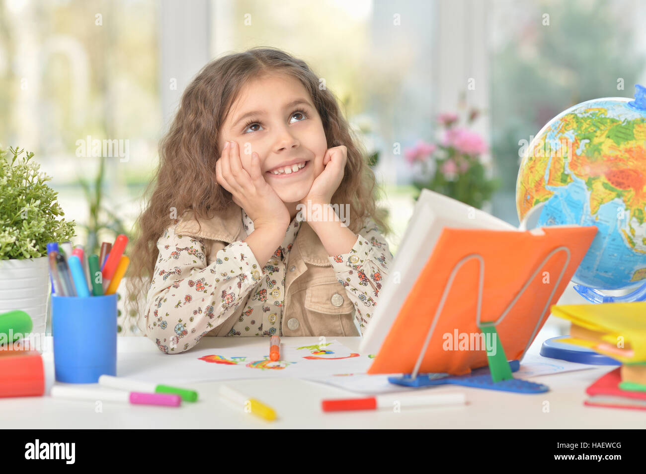 Little girl drawing at class Stock Photo - Alamy