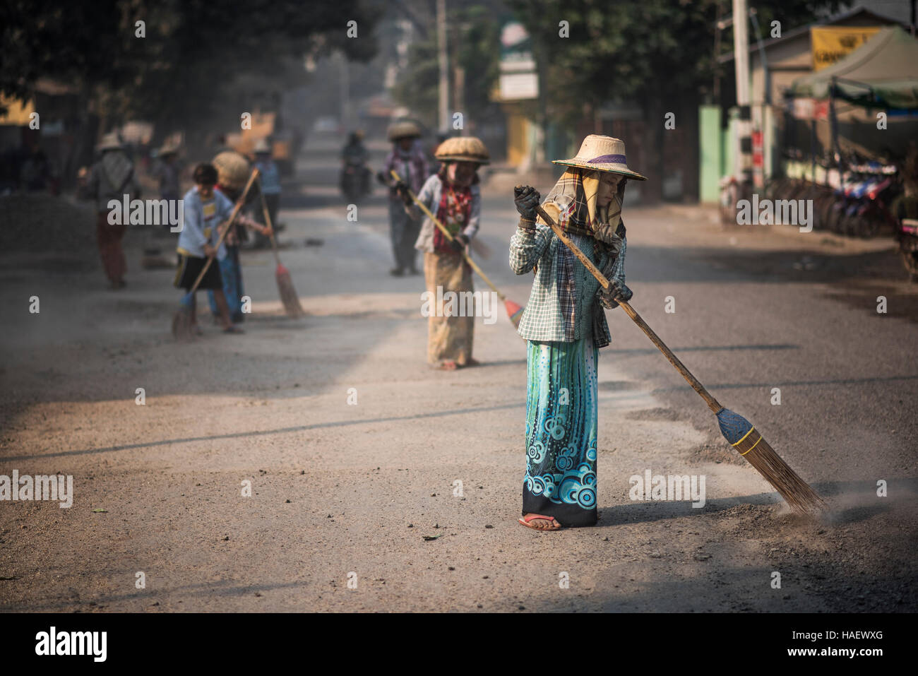 A group of women cleaning the road before laying tar, Bagan, Myanmar ...