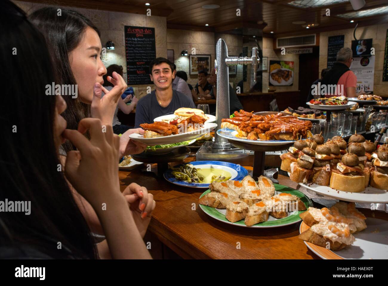 Asian girls tasting Pintxos or Tapas in Bar Old Town, Donostia, San ...
