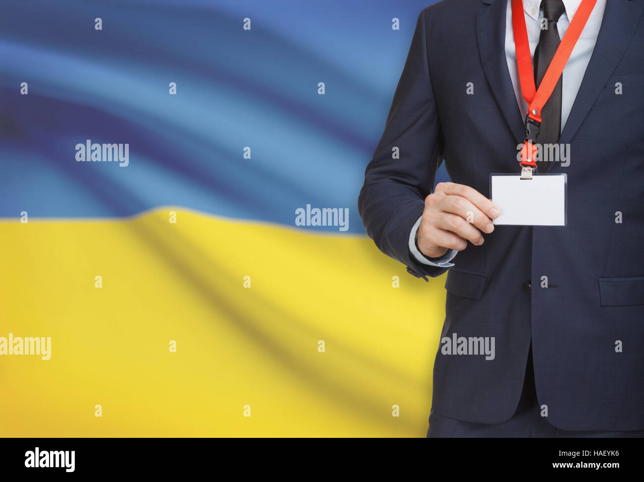 Businessman holding name card badge on a lanyard with a flag on ...