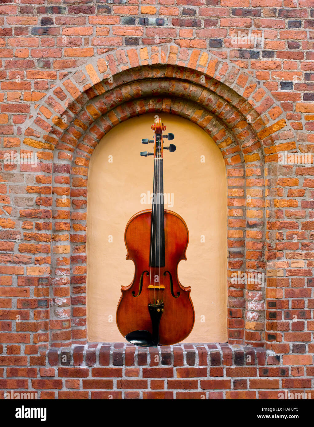The beautiful violin in the blind window in the old brick wall Stock ...