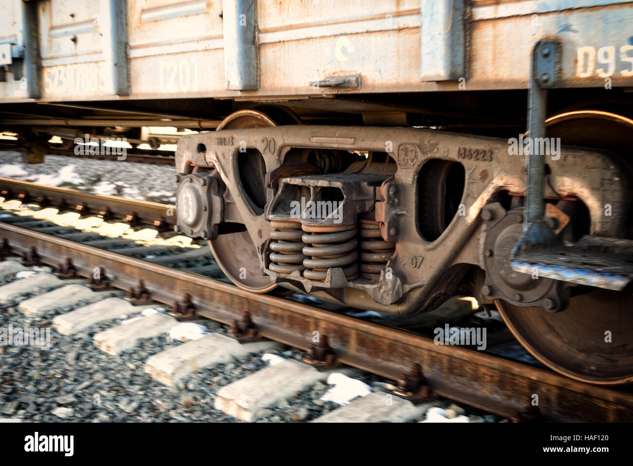 Train wheels of a carriage moving along a train track with slight ...