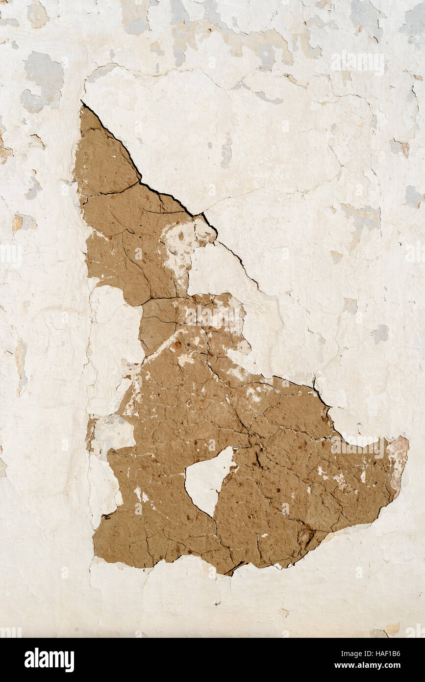 Cracked white plaster all with flaking plastering. Copyspace area for ...