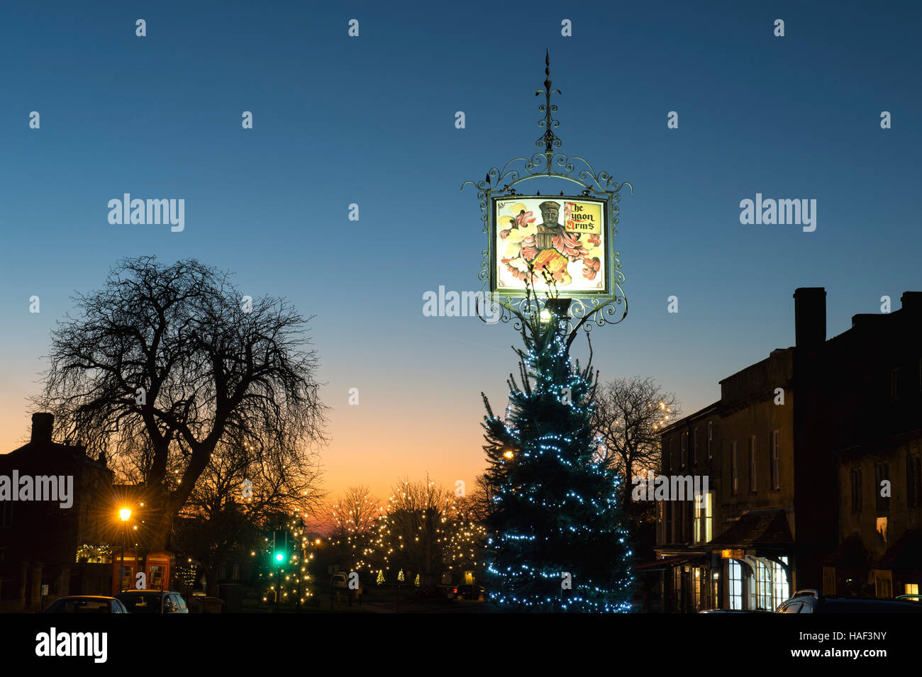 The Lygon Arms sign and a christmas tree with lights at dusk. Broadway ...