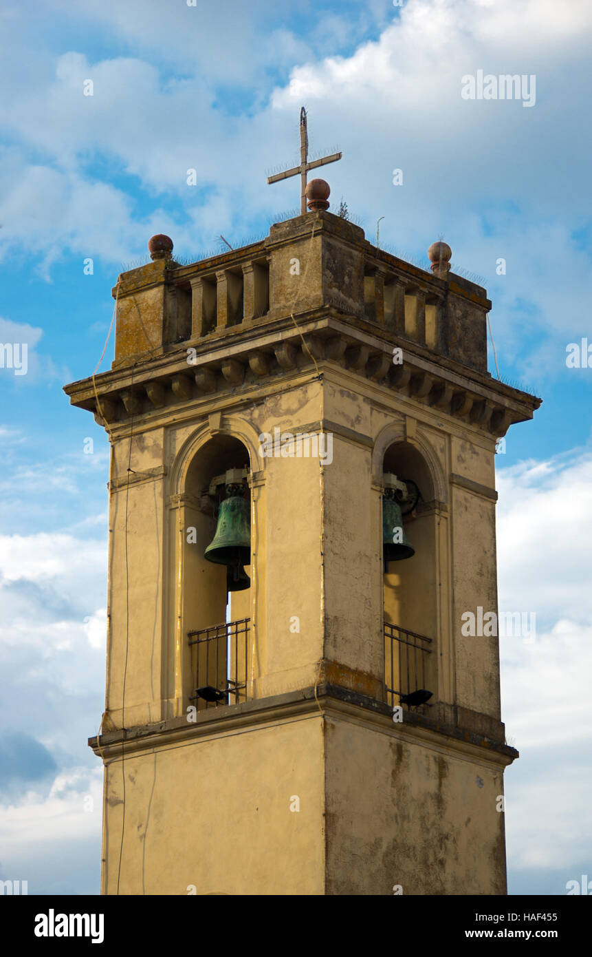 ancient bell tower made of masonry plastered with bronze bells, merlons ...