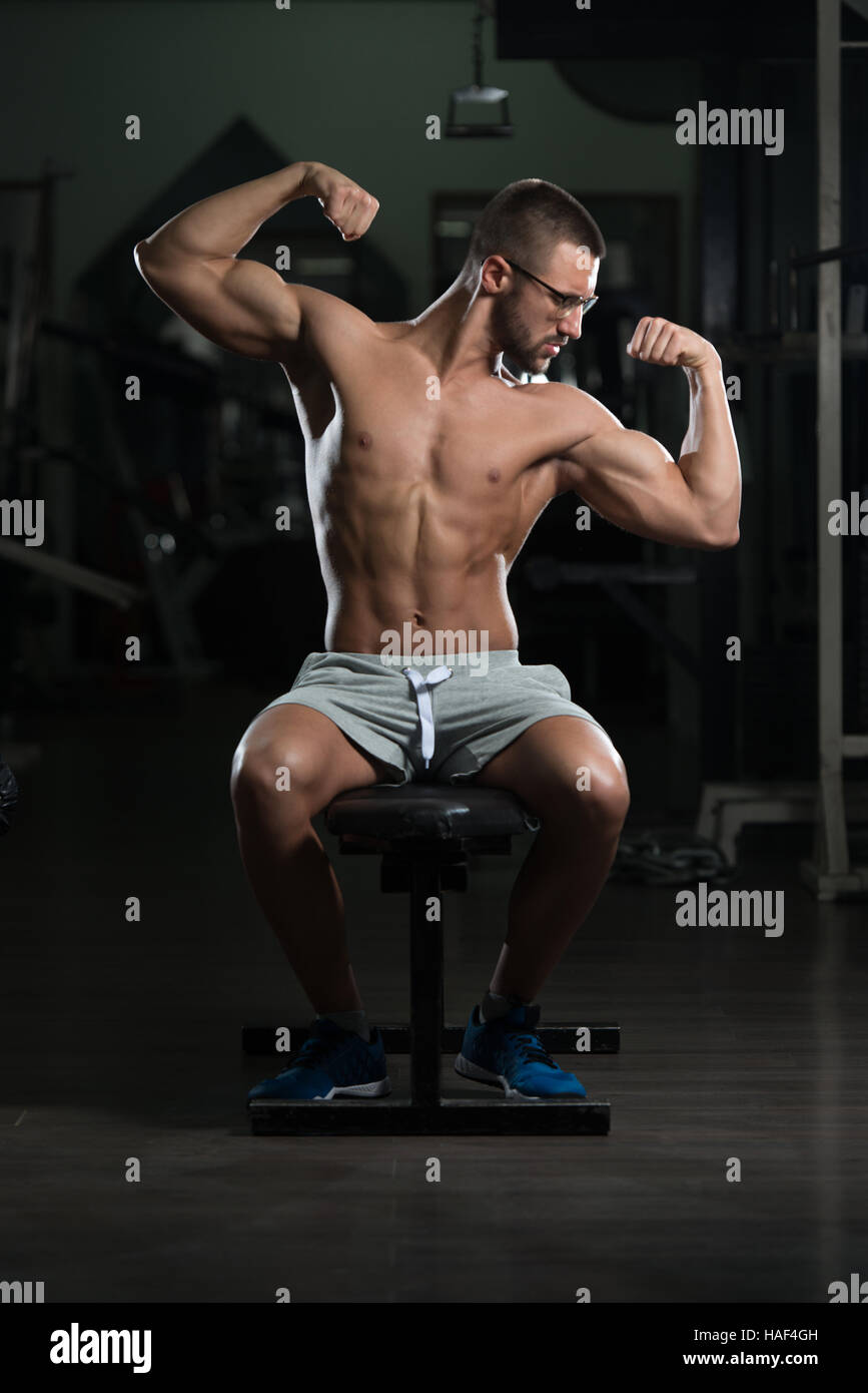 Portrait Of A Young Physically Fit Nerd Man Showing His Well Trained ...