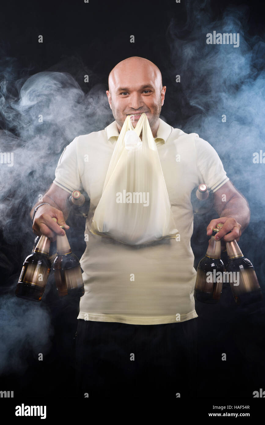 happy man with lots of beer on a black background Stock Photo - Alamy