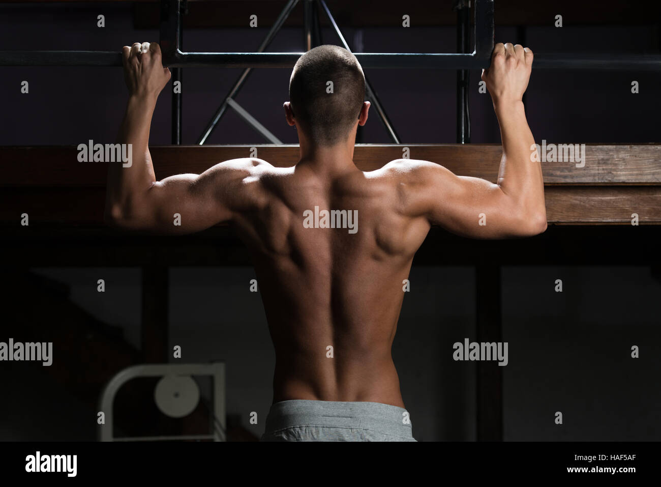 Handsome Man Athlete Doing Pull Ups - Chin-Ups In The Gym Stock Photo ...