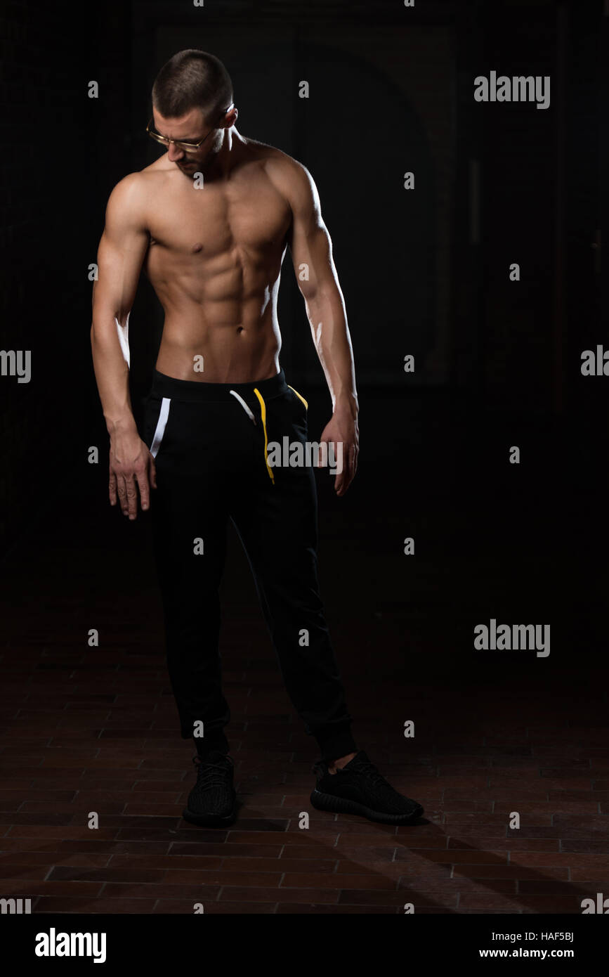 Portrait Of A Young Physically Fit Nerd Man Showing His Well Trained ...