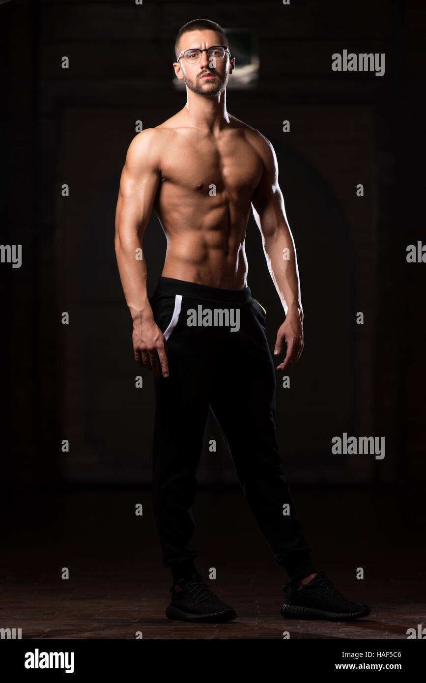 Portrait Of A Young Physically Fit Nerd Man Showing His Well Trained ...