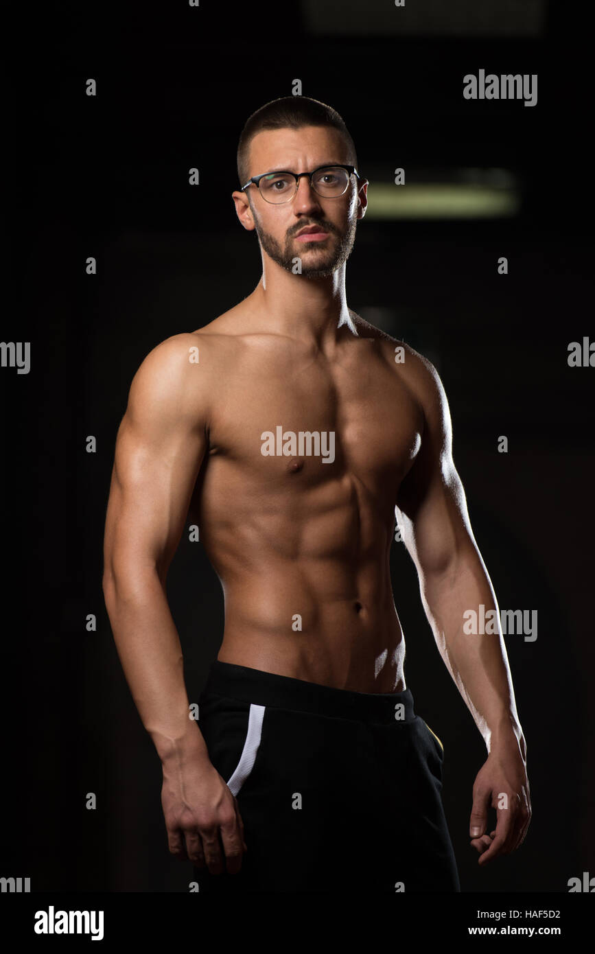 Portrait Of A Young Physically Fit Nerd Man Showing His Well Trained ...
