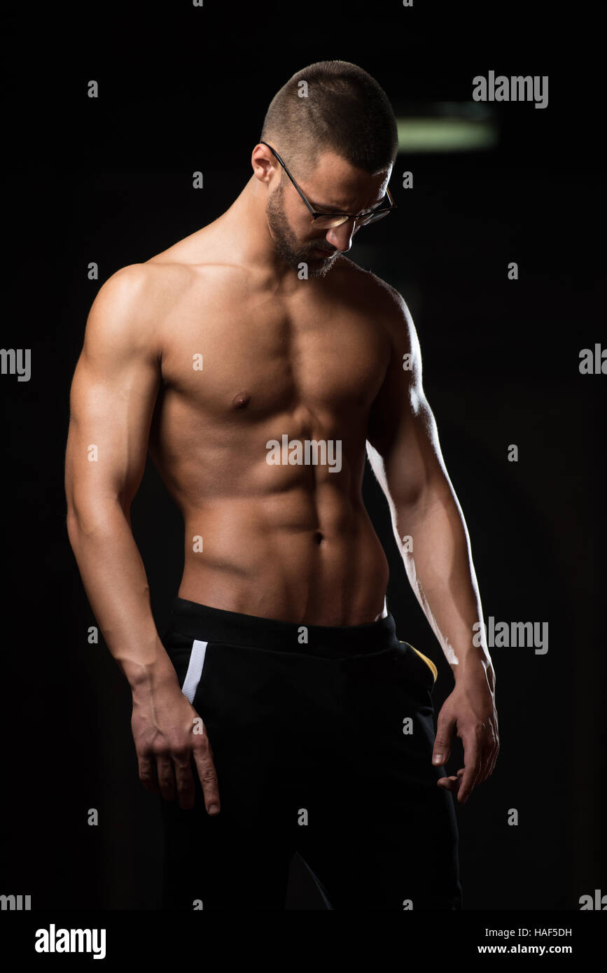 Portrait Of A Young Physically Fit Nerd Man Showing His Well Trained ...