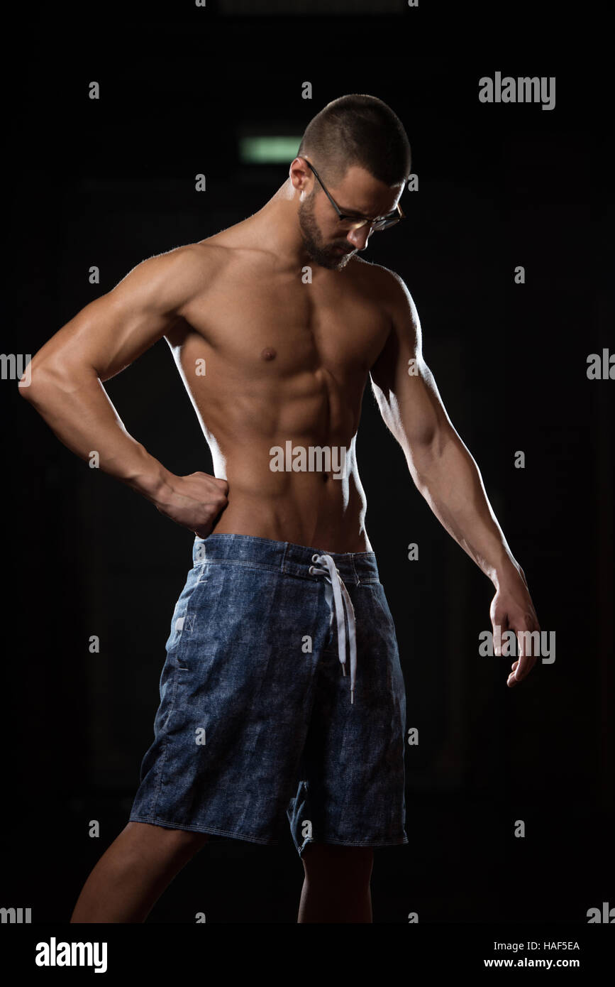Portrait Of A Young Physically Fit Nerd Man Showing His Well Trained ...