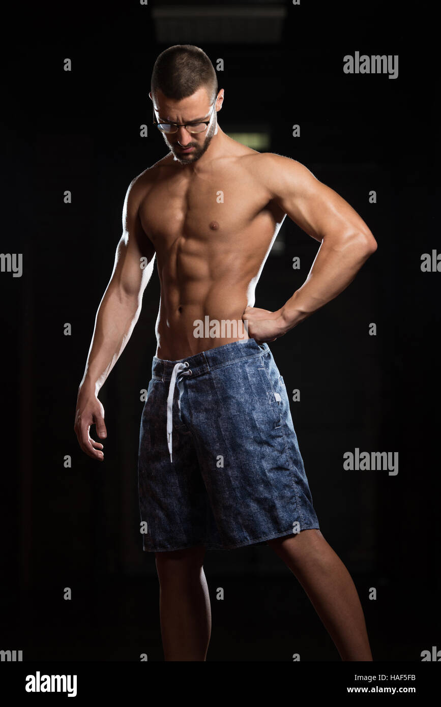 Portrait Of A Young Physically Fit Nerd Man Showing His Well Trained ...