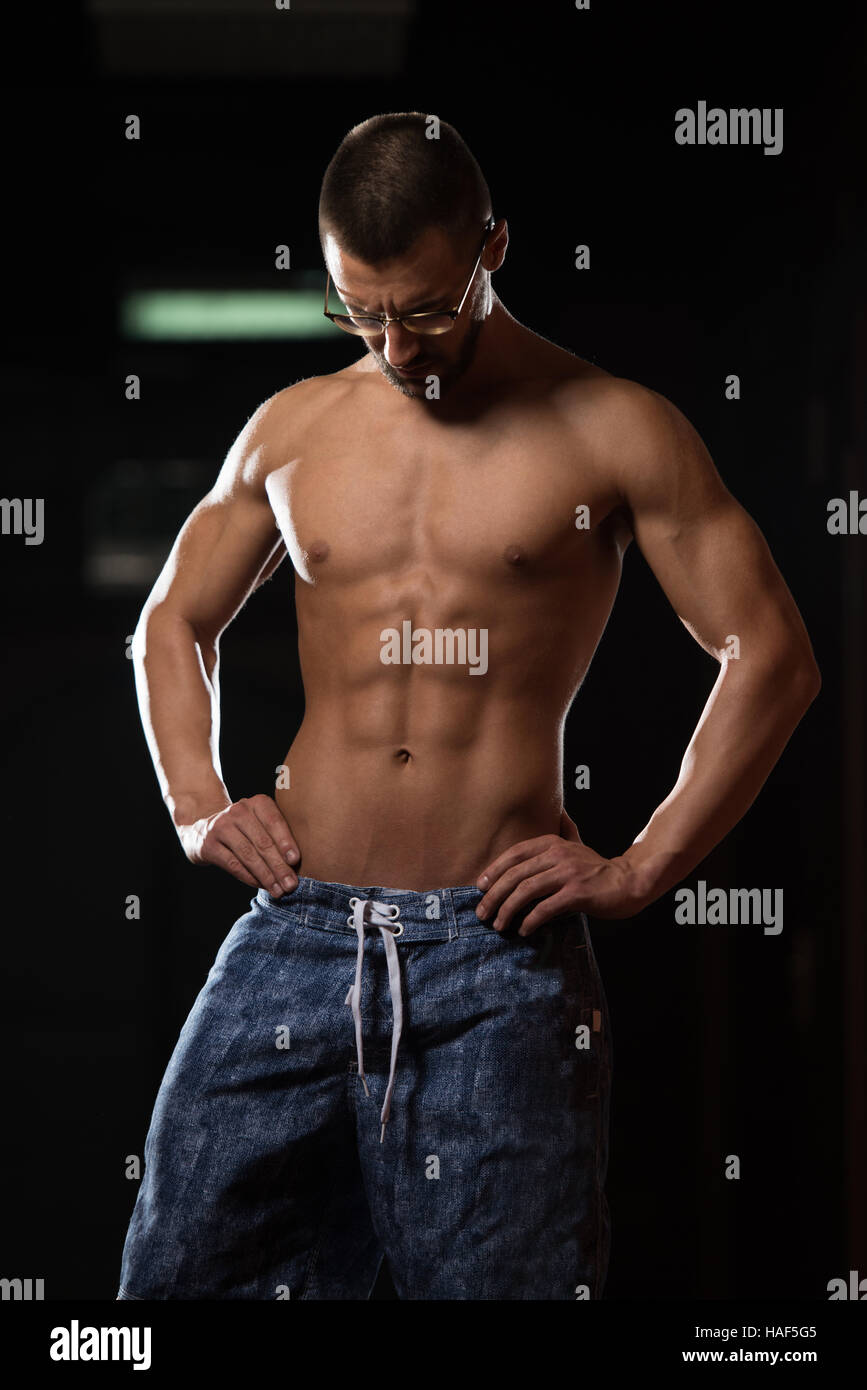 Portrait Of A Young Physically Fit Nerd Man Showing His Well Trained ...