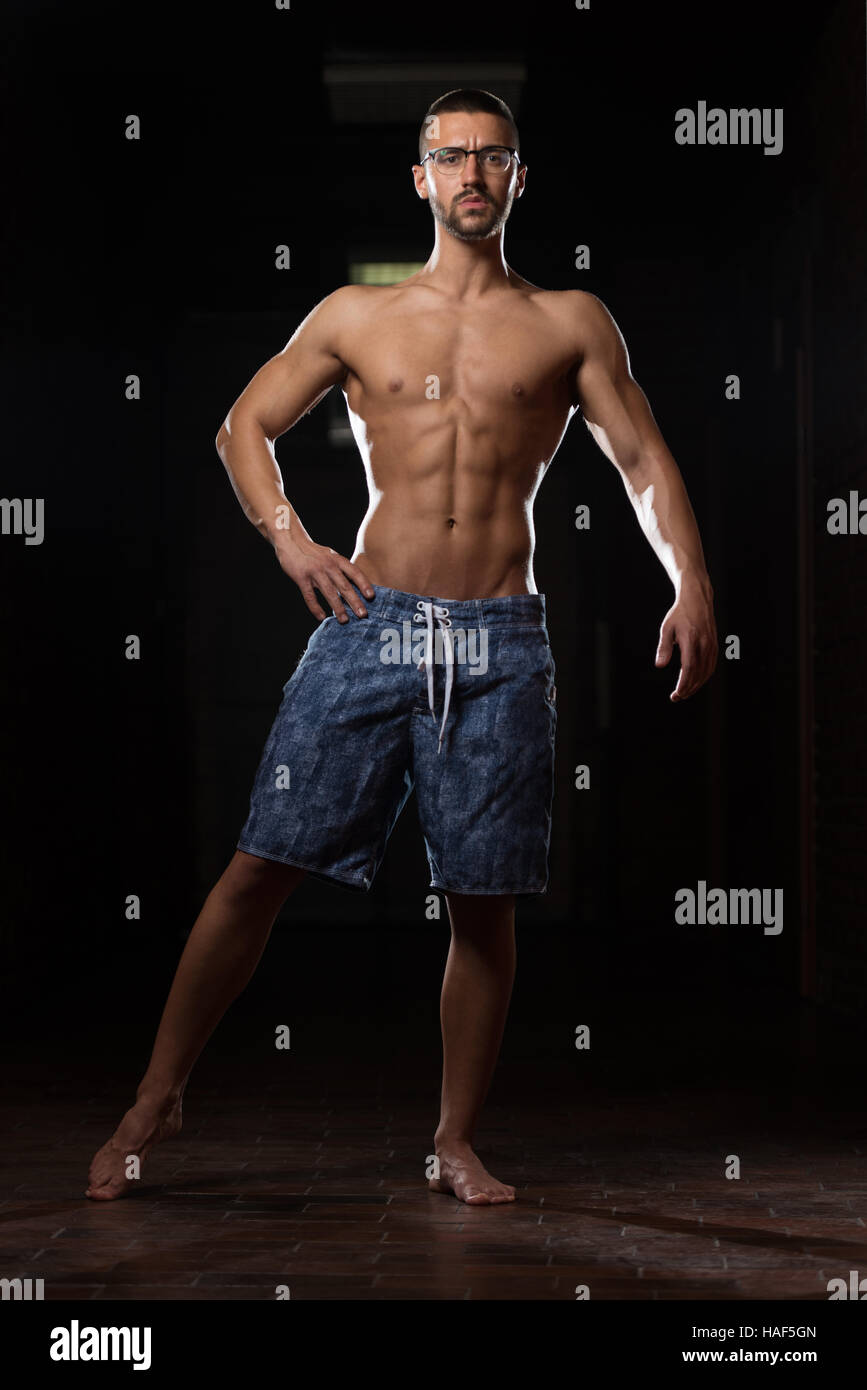 Portrait Of A Young Physically Fit Nerd Man Showing His Well Trained ...