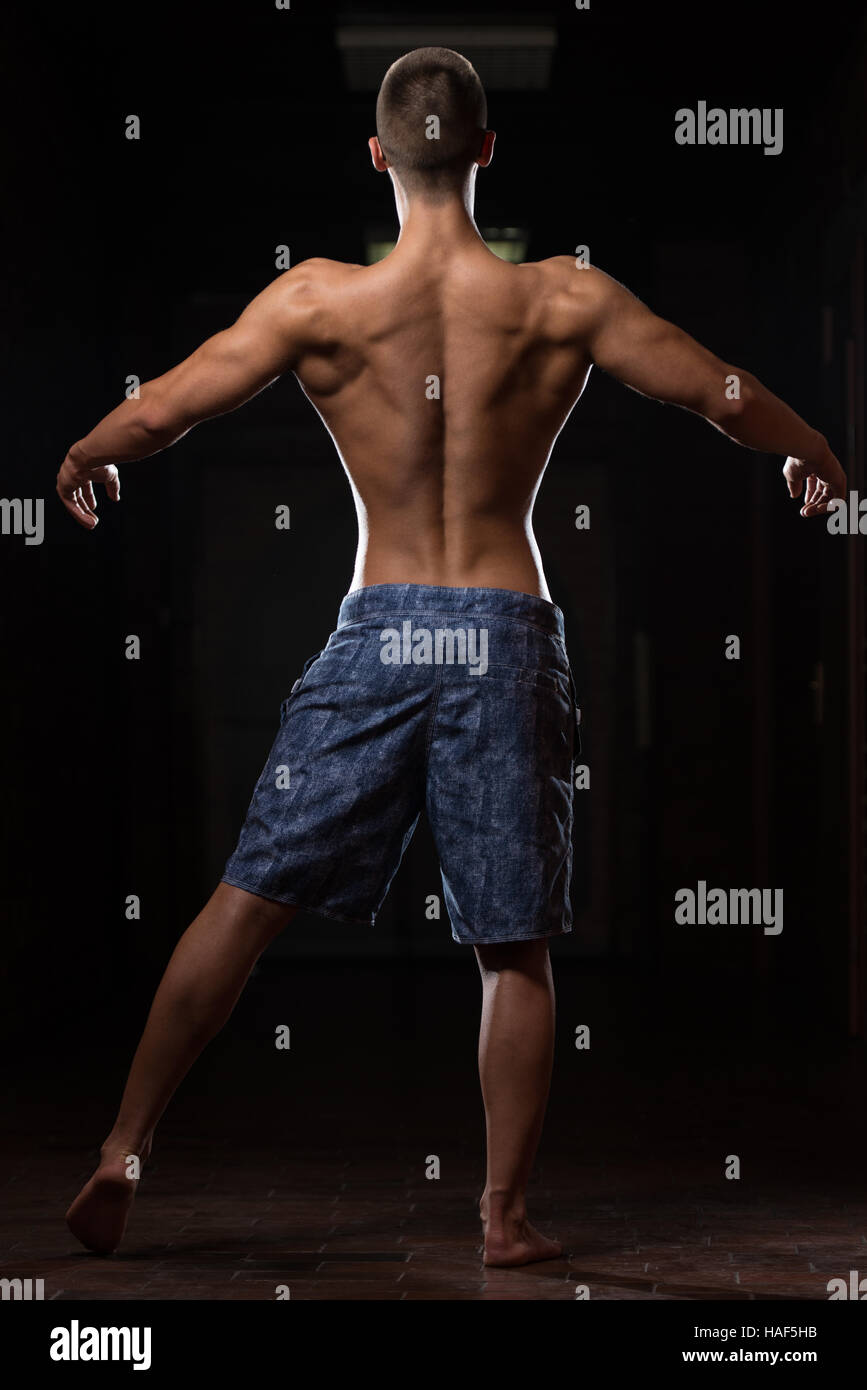 Portrait Of A Young Physically Fit Nerd Man Showing His Well Trained ...